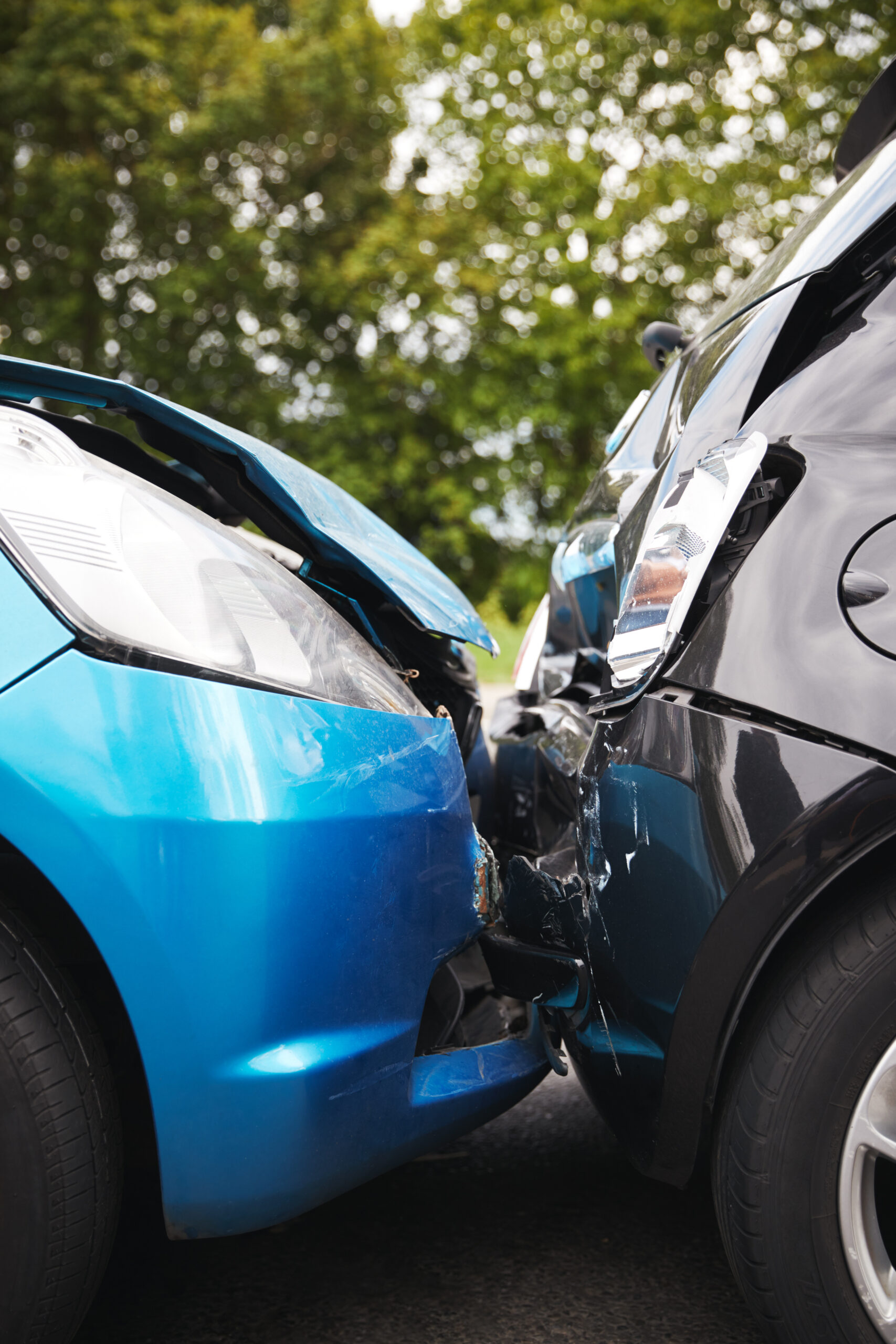 Close Up Of Two Cars Damaged In Road Traffic Accident - Humbrecht Law PLLC
